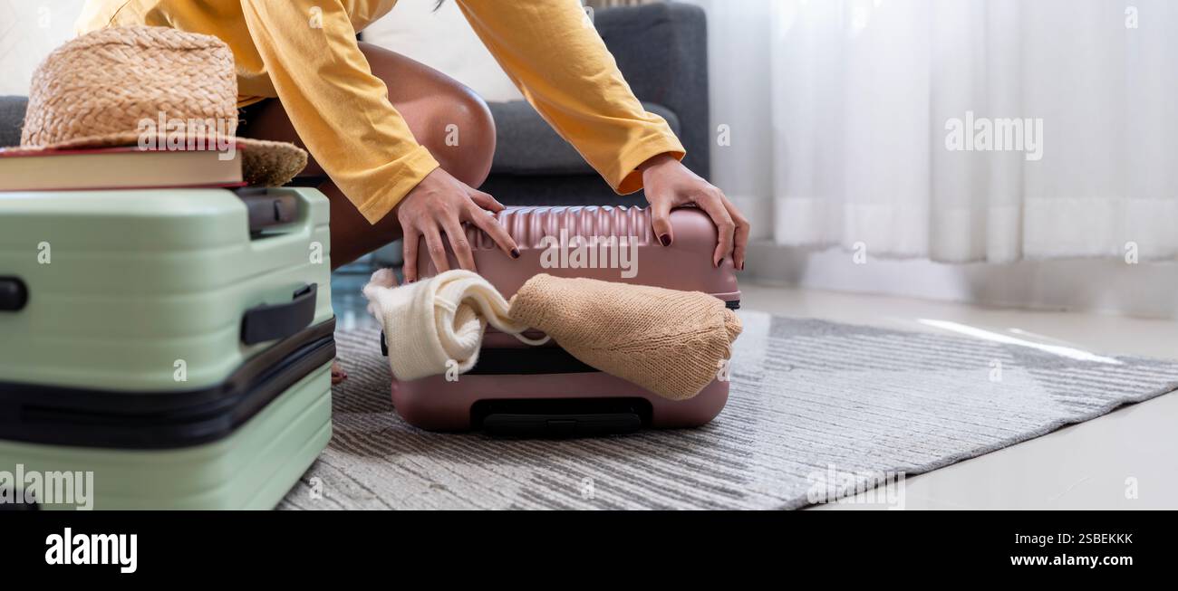 Always prepared. Woman sorting through clothes in bag. Packing for ...