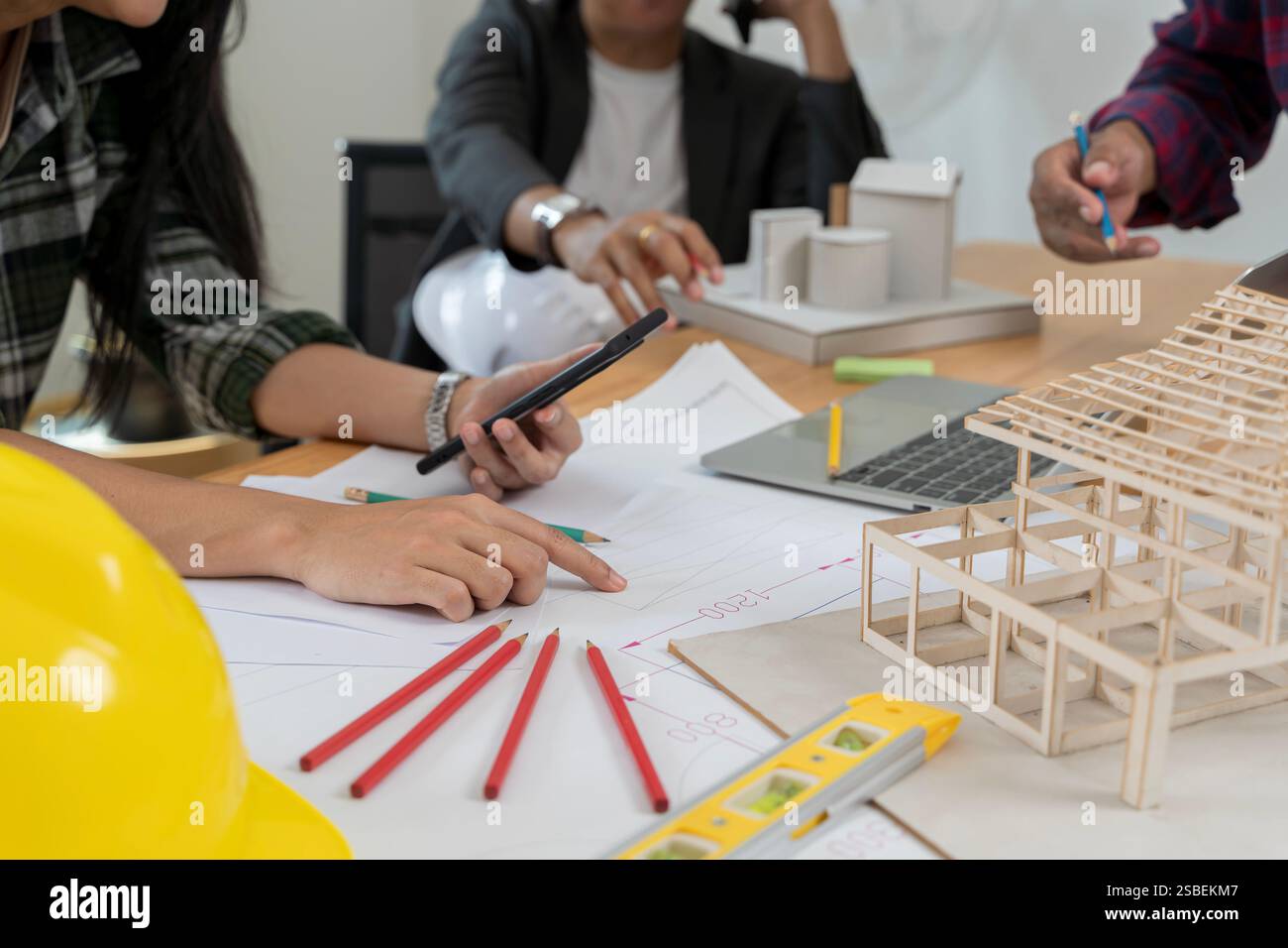 Confident businesswoman holding architectural model in office. A ...