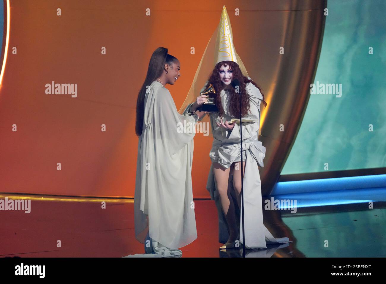 Victoria Monet, left, presents the award for best new artist to ...