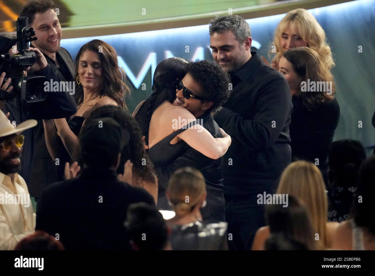 Lady Gaga, left, and Bruno Mars embrace as they win the award for best ...