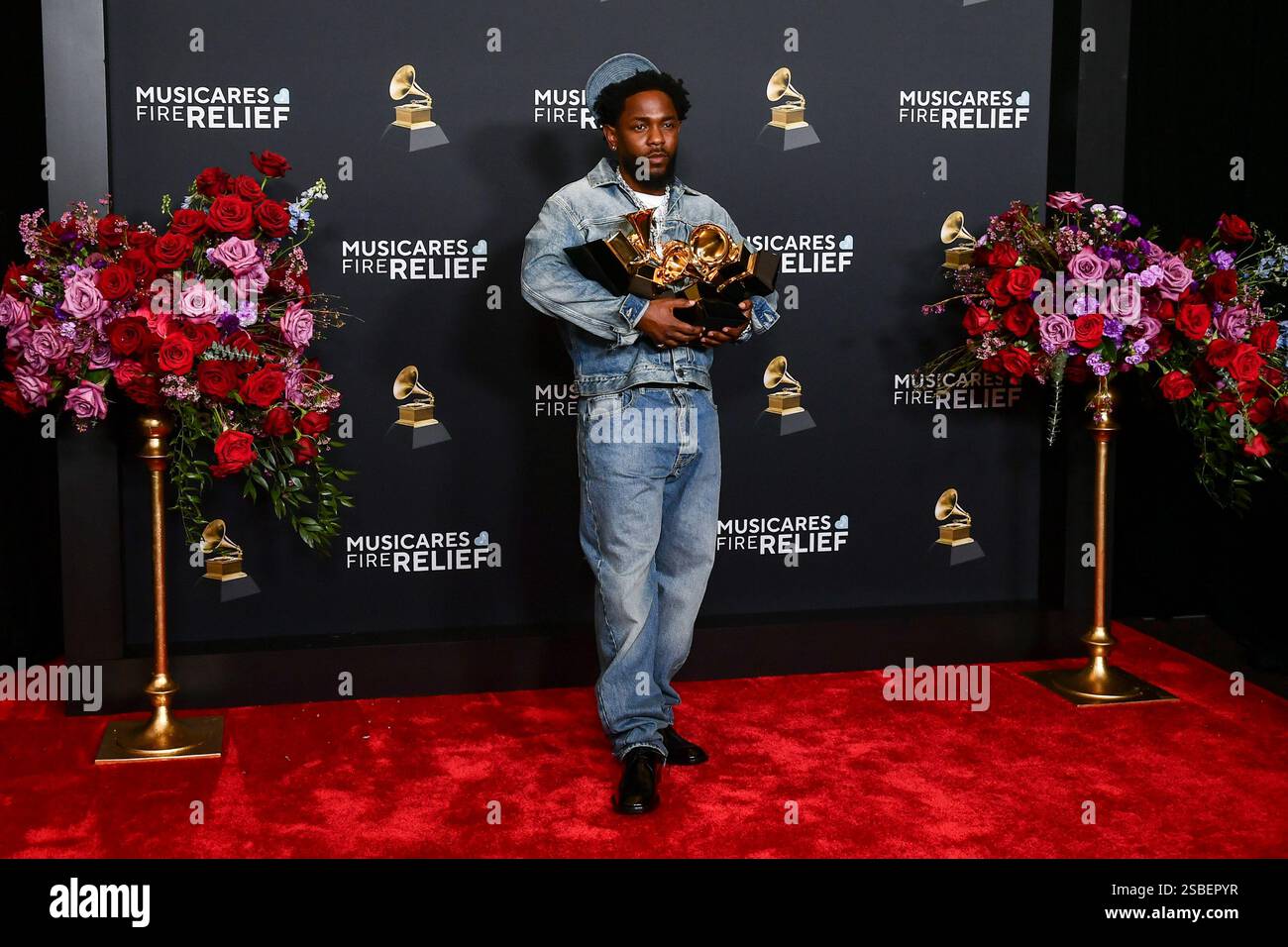 Kendrick Lamar poses in the press room with the award for record of the ...