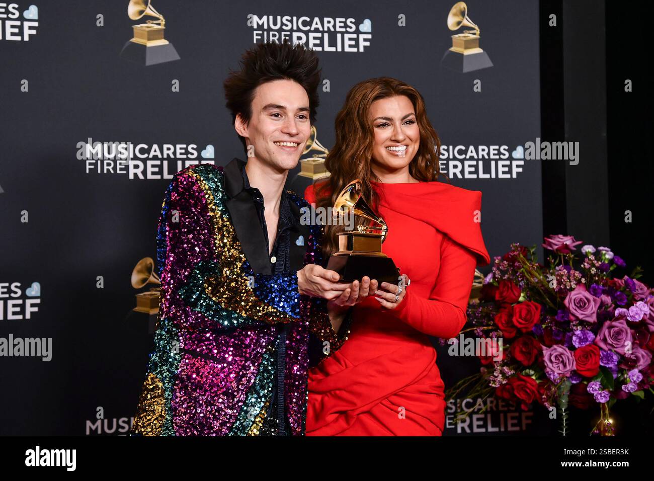 Jacob Collier, left, and Tori Kelly pose in the press room with the award for best arrangement ...