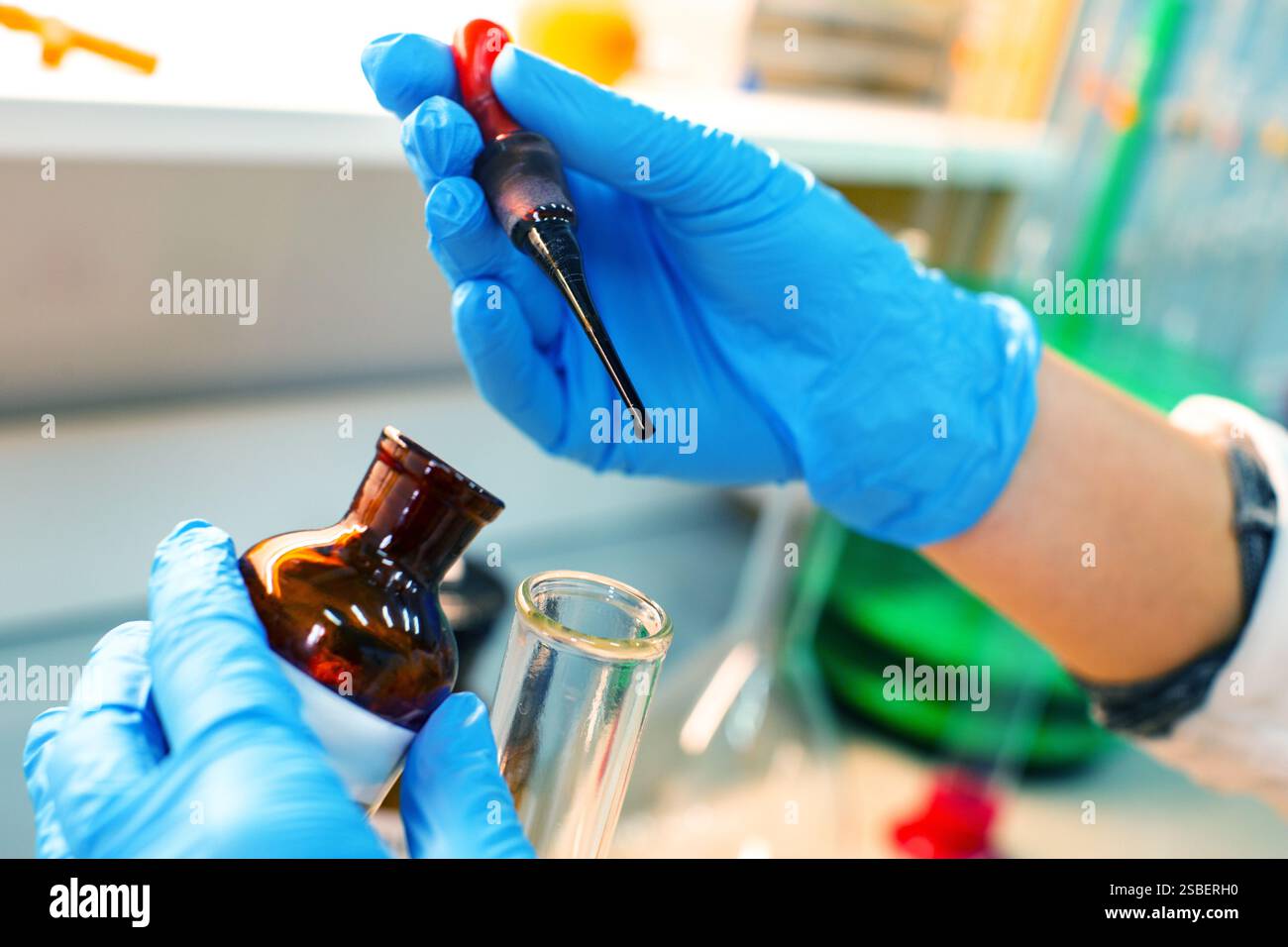 Lab technician conducts an experiment using pipette and glass vial in a ...
