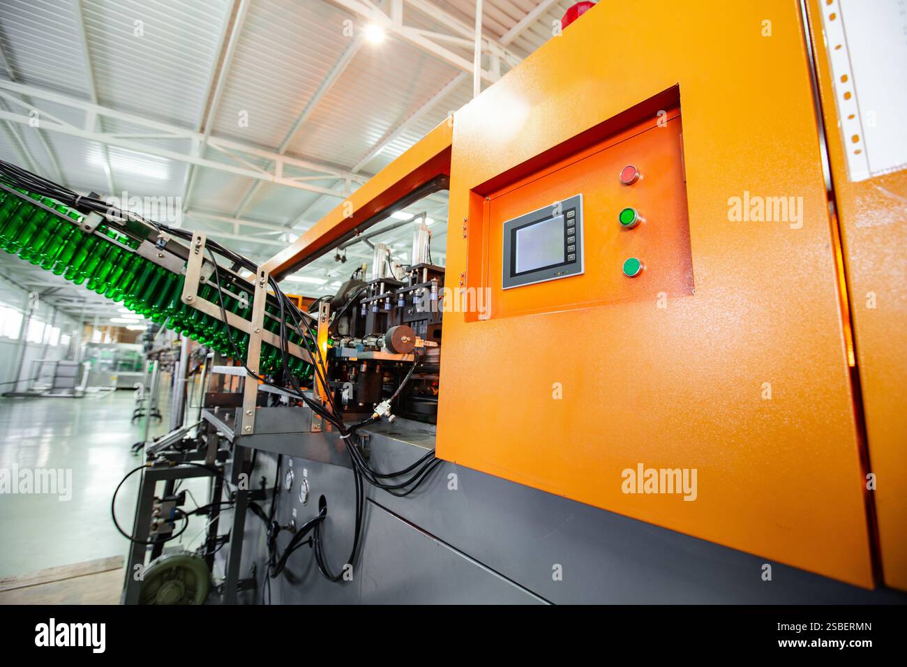 Industrial machinery operates a production line in a modern factory ...
