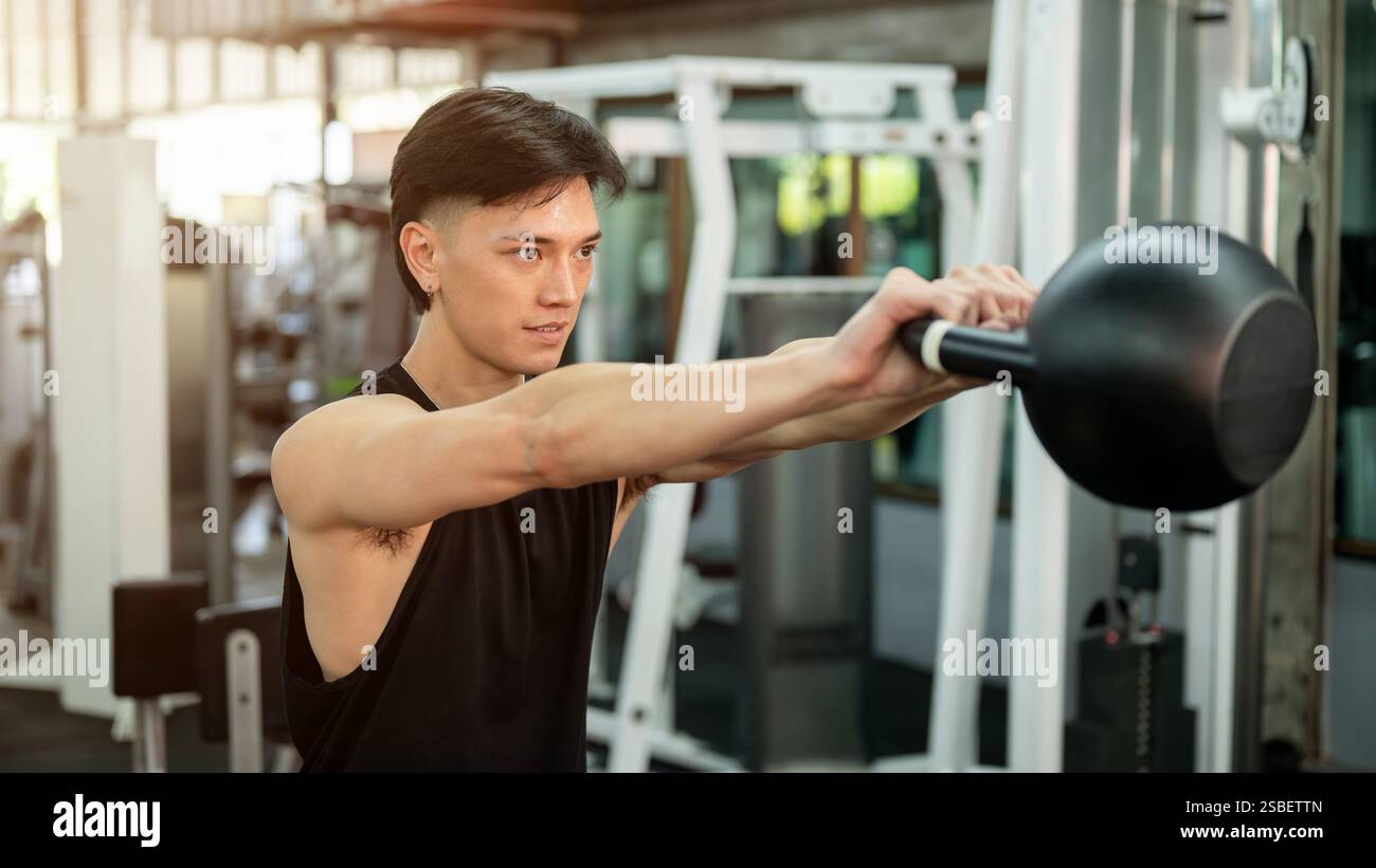 A determined and strong Asian man in sportswear is working out with a ...