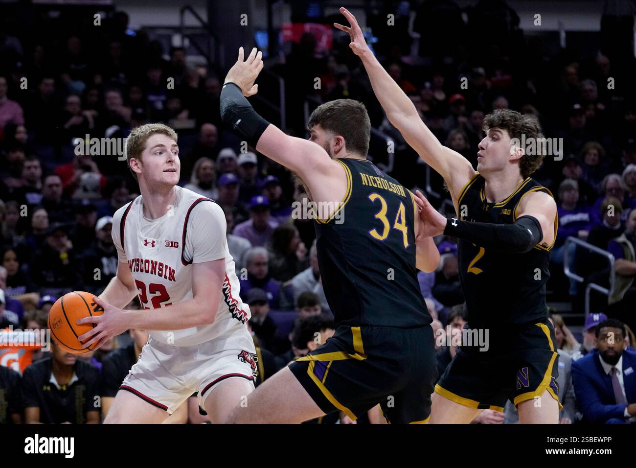 Wisconsin forward Steven Crowl, left, looks to pass against ...