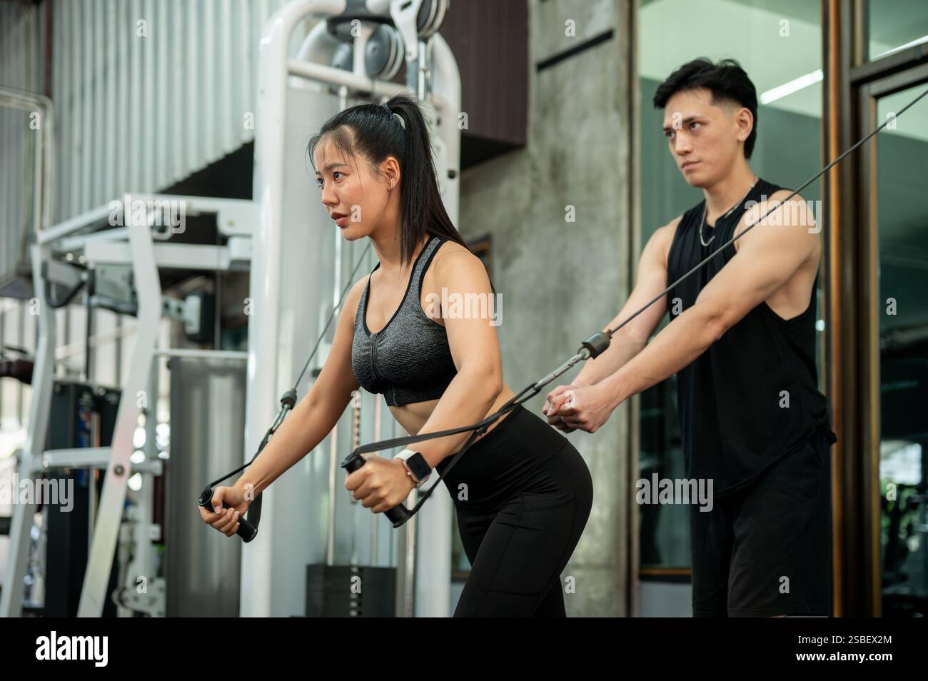 A healthy and determined Asian female client is working with a ...