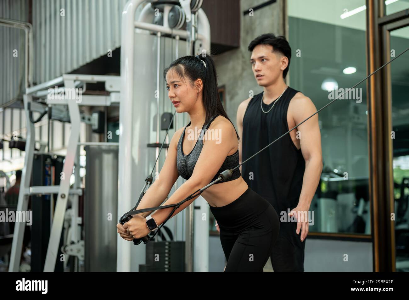 A healthy and determined Asian female client is working with a ...