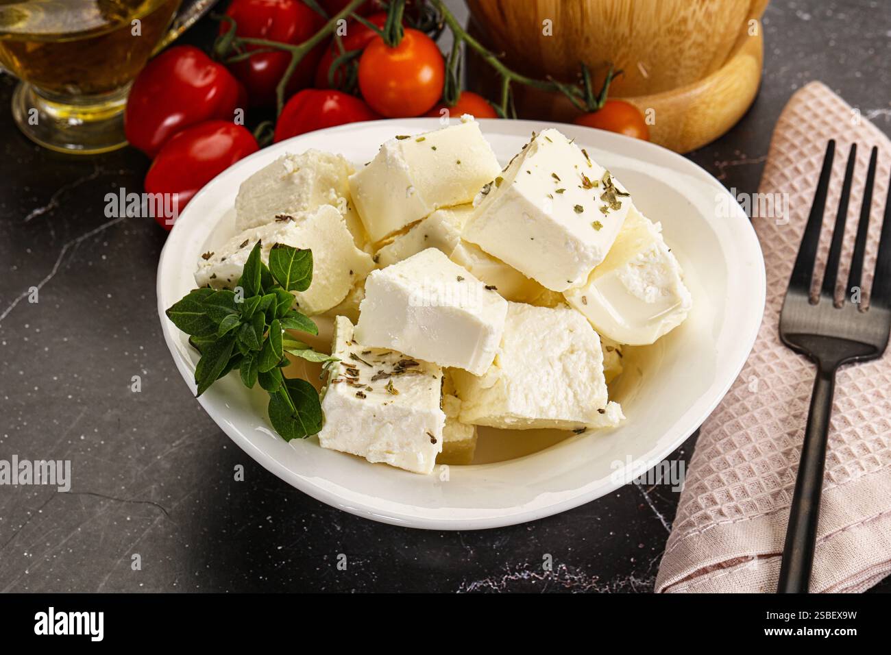 Greek traditional Feta cheese cubes with herbs and spices Stock Photo ...