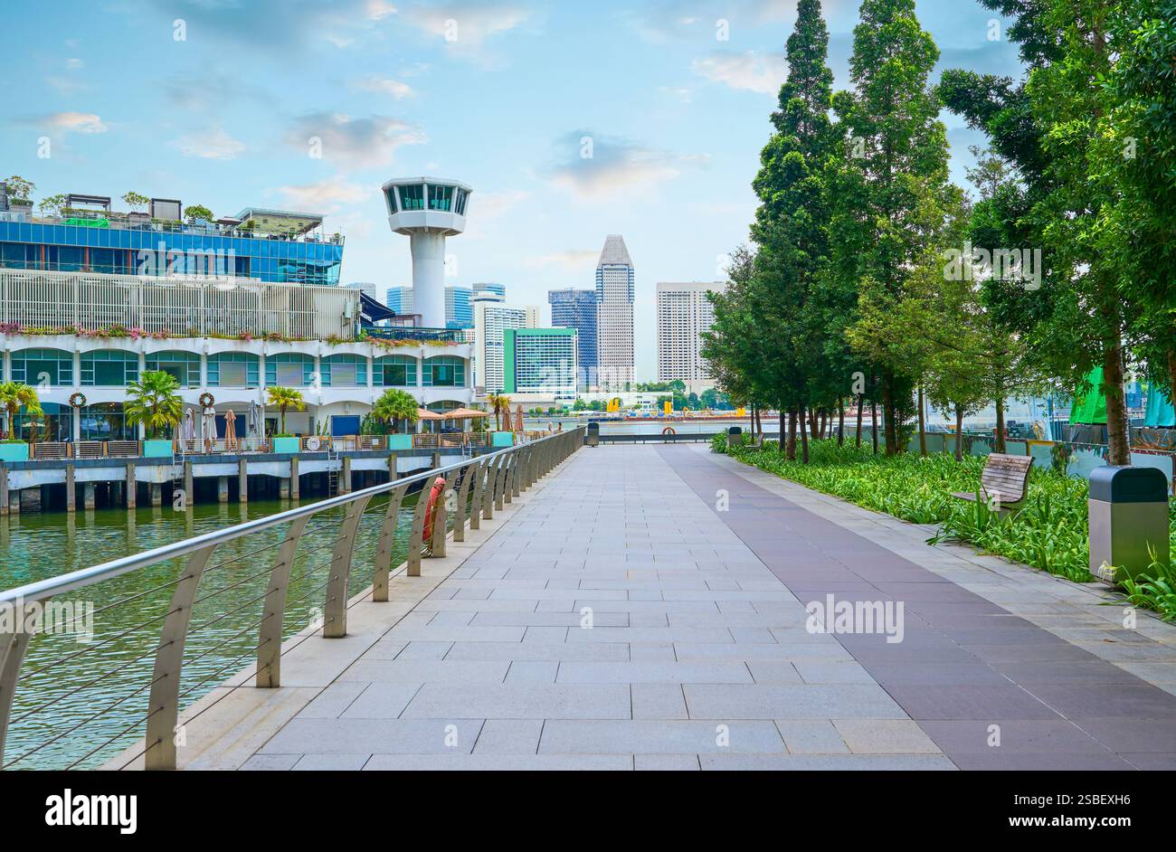 Modern cityscape of singapore featuring a paved promenade lined with ...