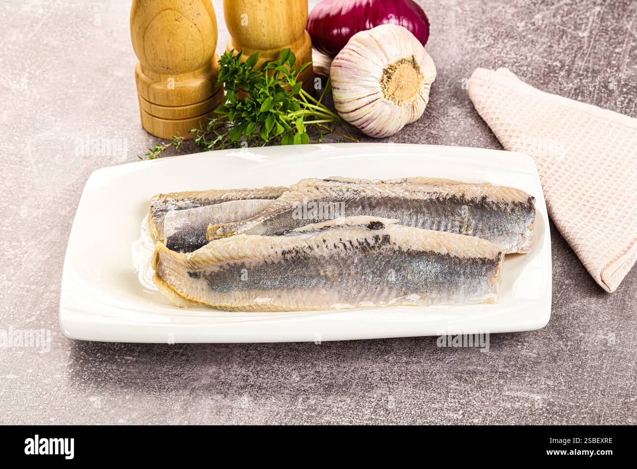 Marinated salted herring fillet apetizer with oil Stock Photo - Alamy