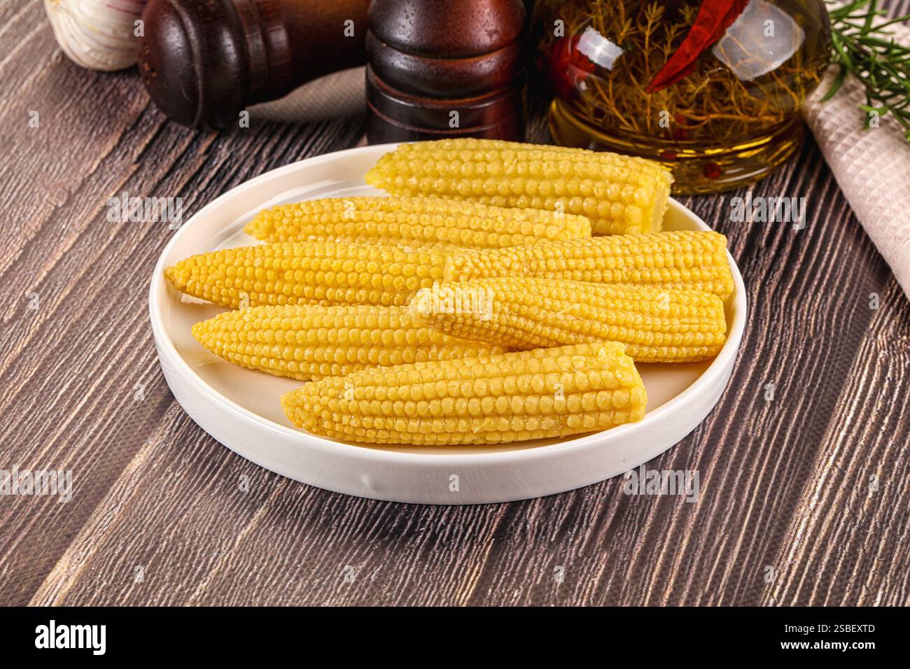 Canned baby mini corn cob in the plate Stock Photo - Alamy