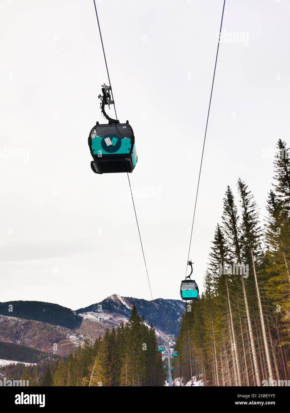 Funicular on ski slope. Climbing to the top of the mountain. Cable car ...