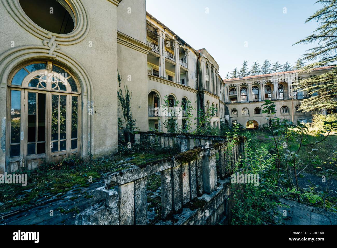 Exterior of abandoned neoclassical building with arched windows ...