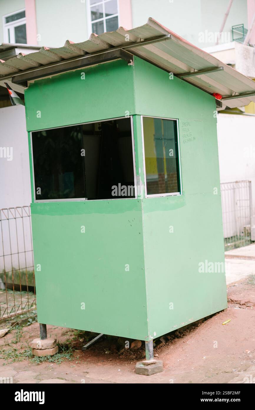 Small, green security booth with a window Stock Photo - Alamy
