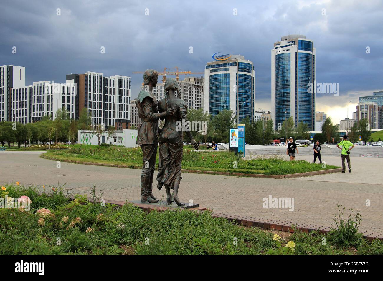 A park located in the city center. Statue of a young boy and girl in ...