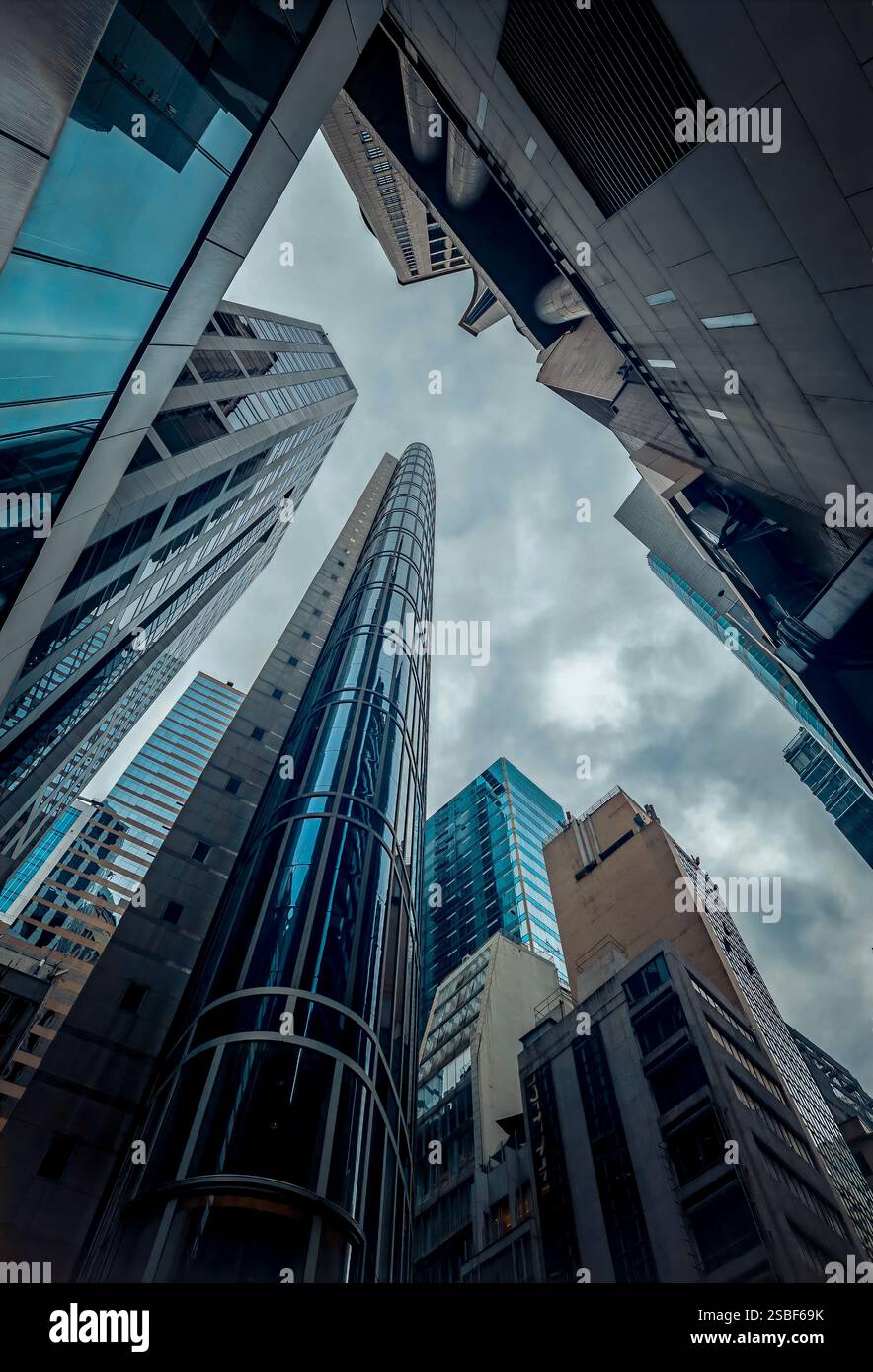 A low-angle, close-up view of towering skyscrapers in Hong Kong ...