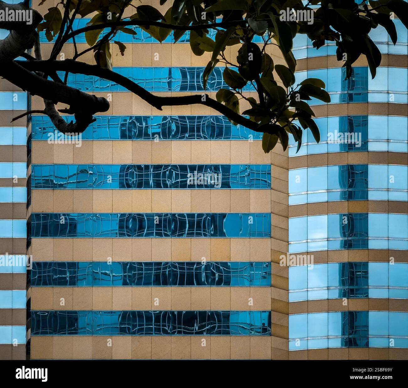 Close-up view of modern Hong Kong architecture. Tan and teal glass ...