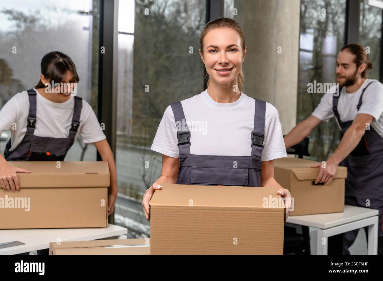 Group of young people packing the boxes and looking involved Stock ...
