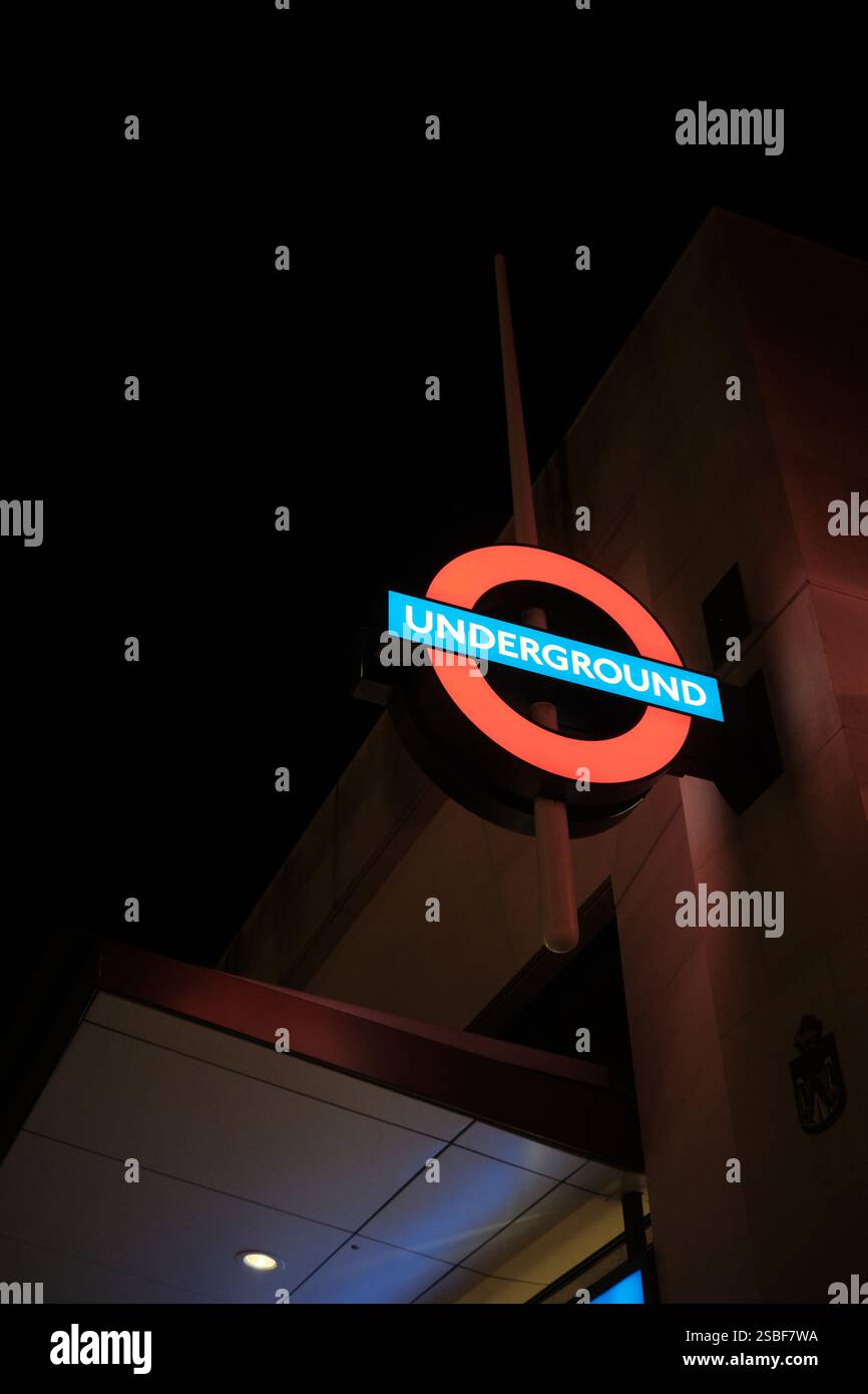 The iconic London Underground sign lit up outside Cannon Street tube ...