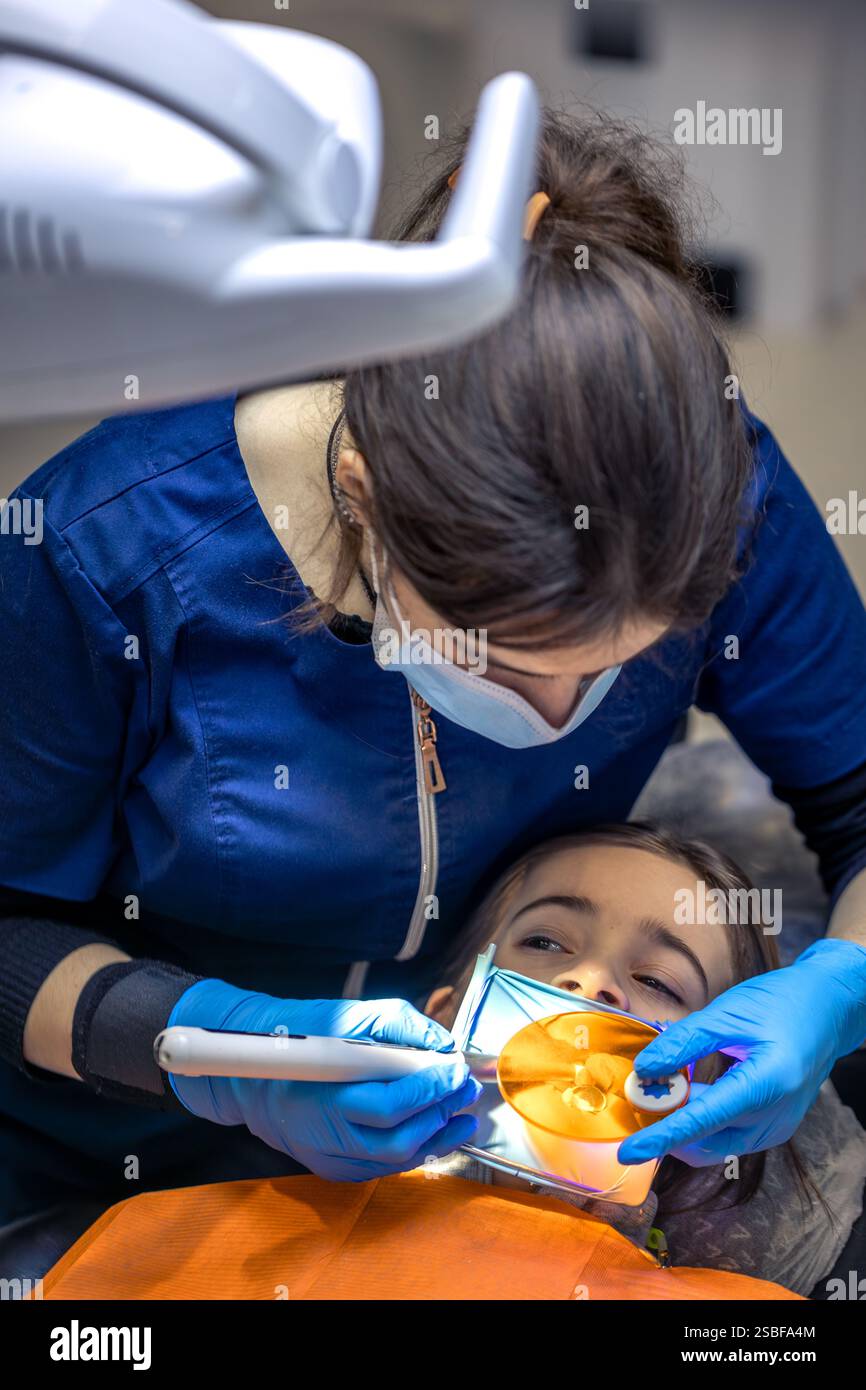 Dental fillings. Dental fillings with ultraviolet light. Female dentist ...