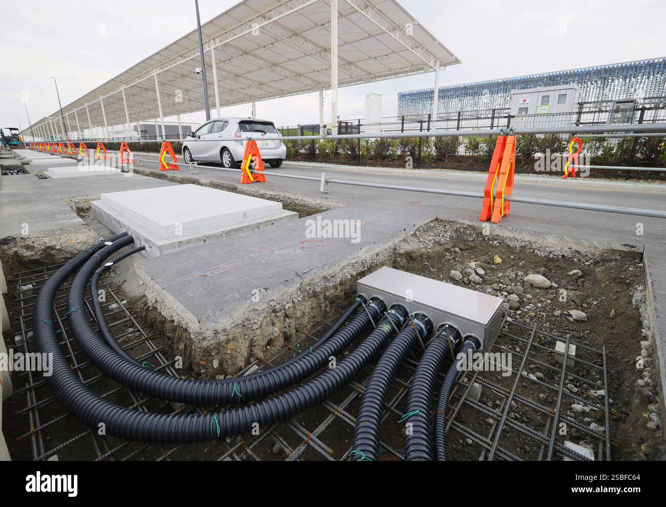 A photo shows a construction site for a system that embeds coils in the ...