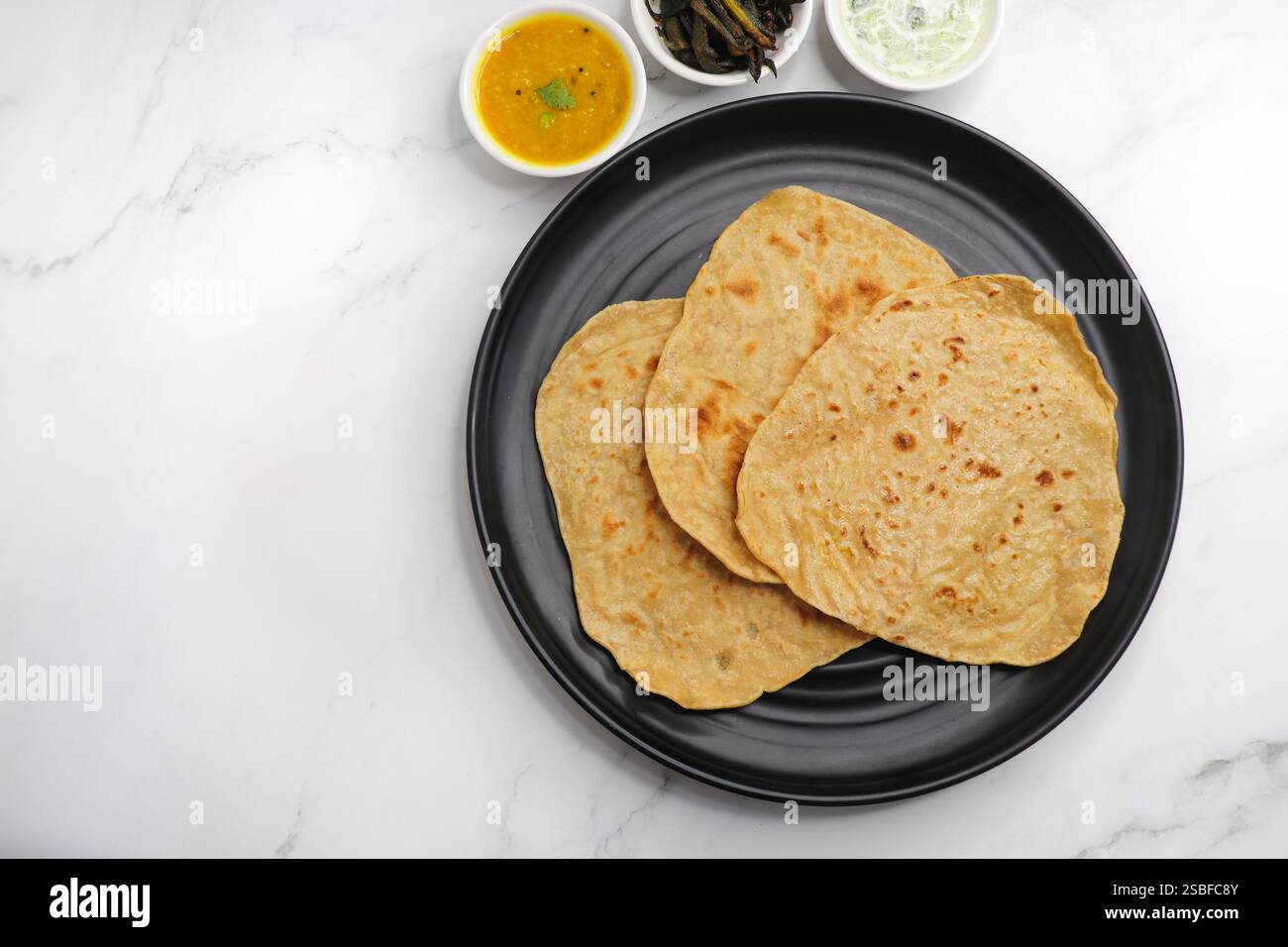 Roti and Sabzi. Indian vegetarian Thali includes bhindi fry, yellow ...