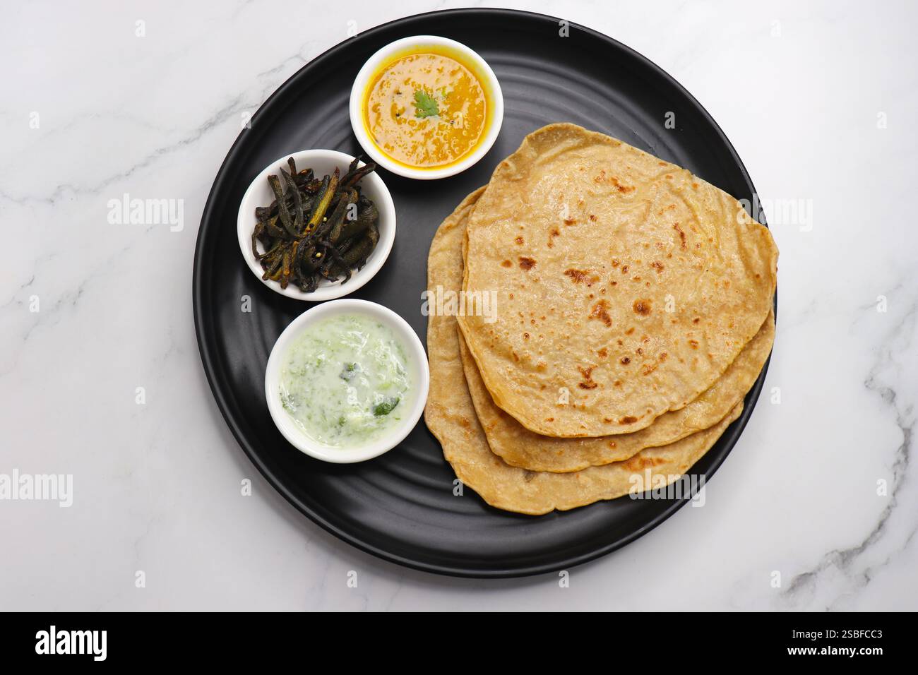 Roti and Sabzi. Indian vegetarian Thali includes bhindi fry, yellow ...
