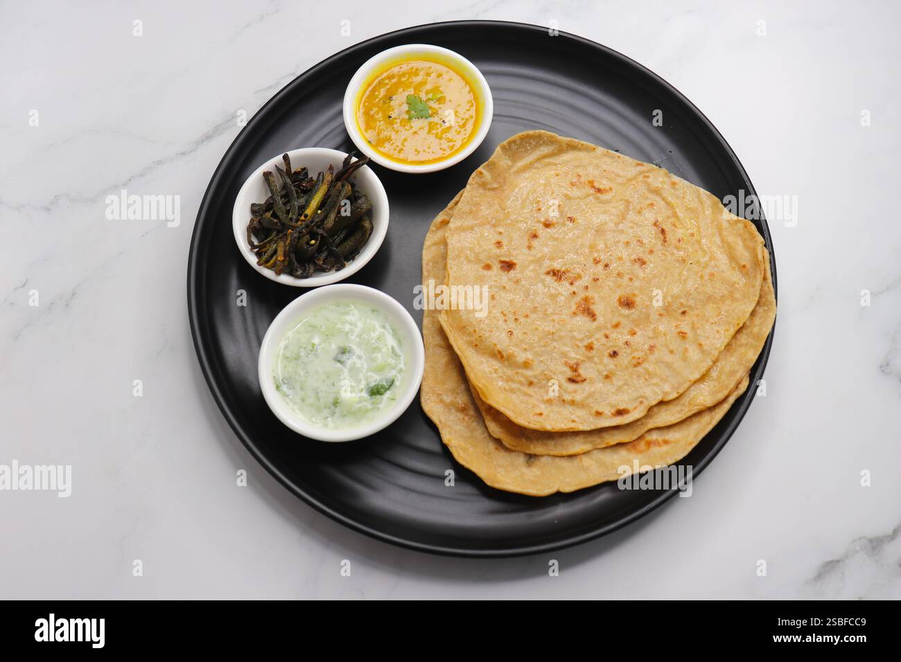 Roti and Sabzi. Indian vegetarian Thali includes bhindi fry, yellow ...