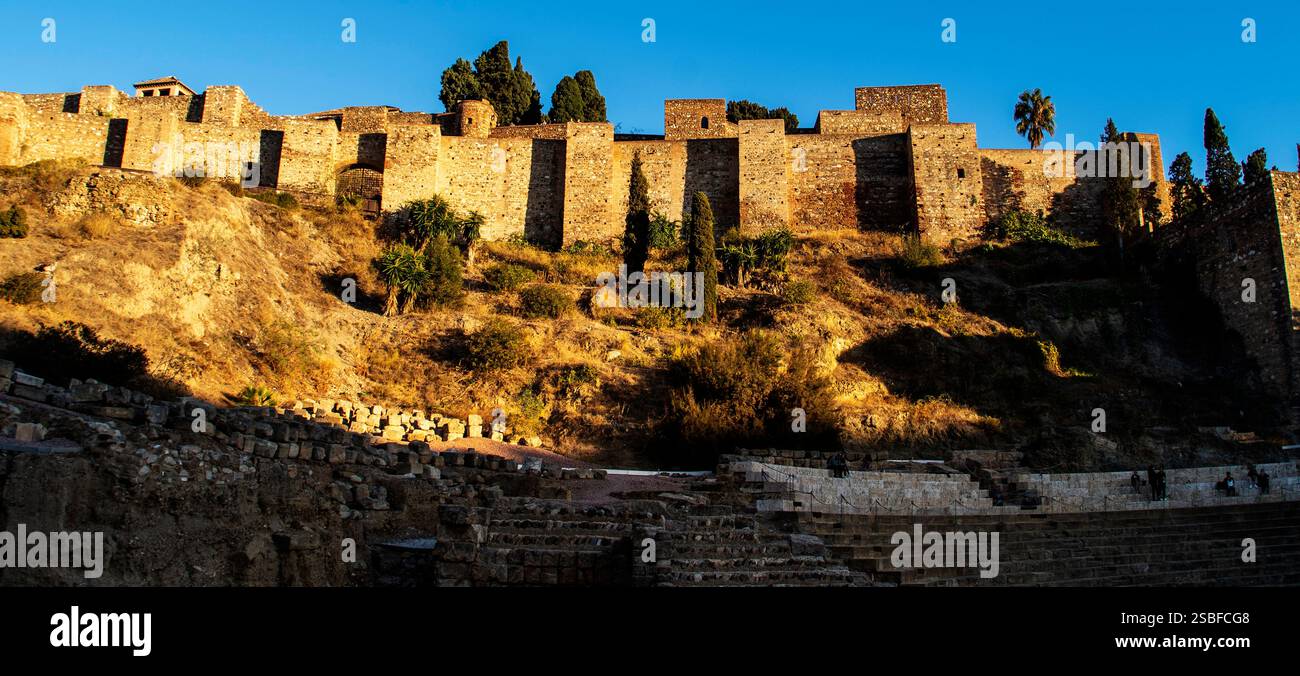 A scenic view of ancient stone walls and ruins atop a hill, bathed in ...