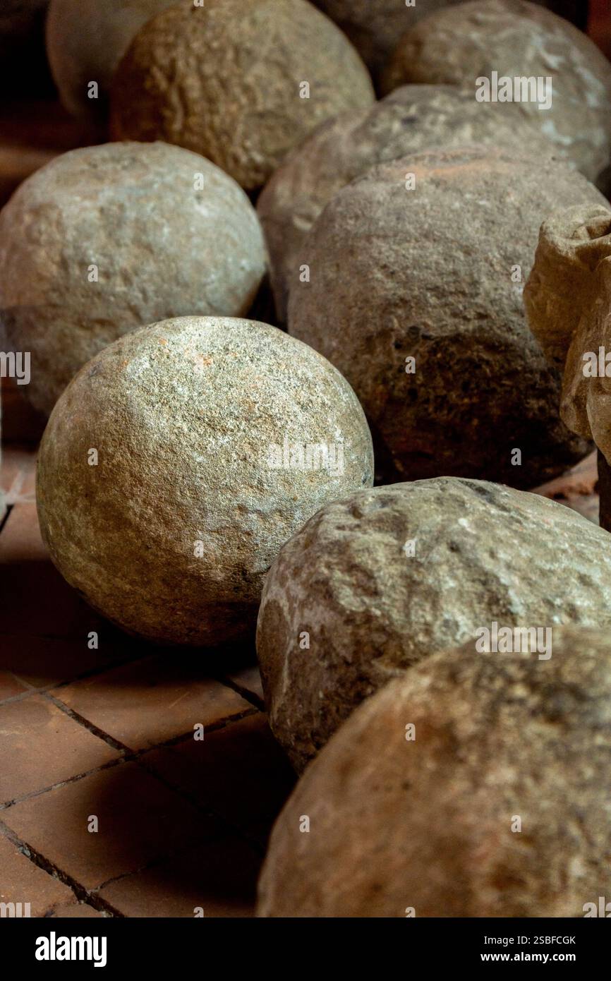 Medieval stone projectiles arranged on a tiled floor Stock Photo - Alamy