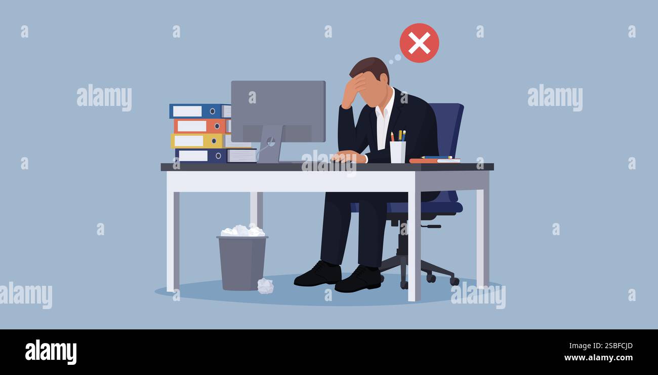 Desperate stressed businessman sitting at the office desk and working ...