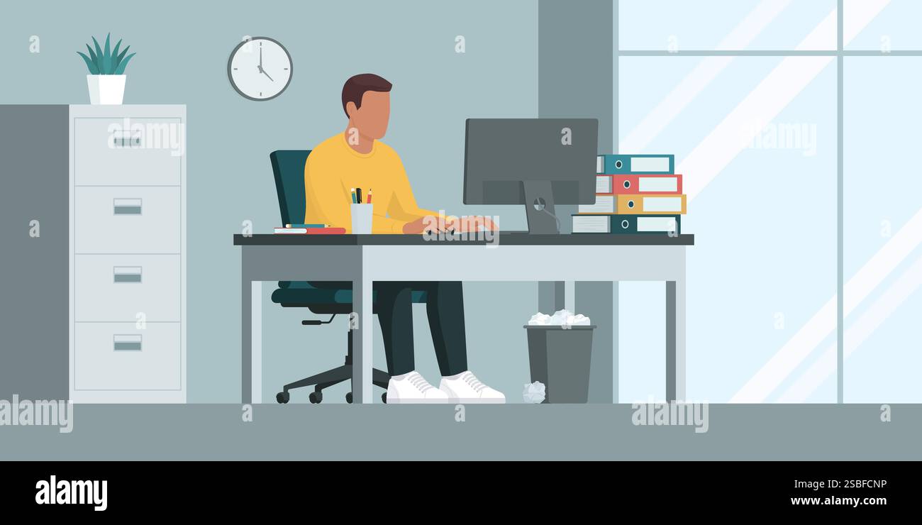 Efficient creative young employee sitting at the office desk and ...