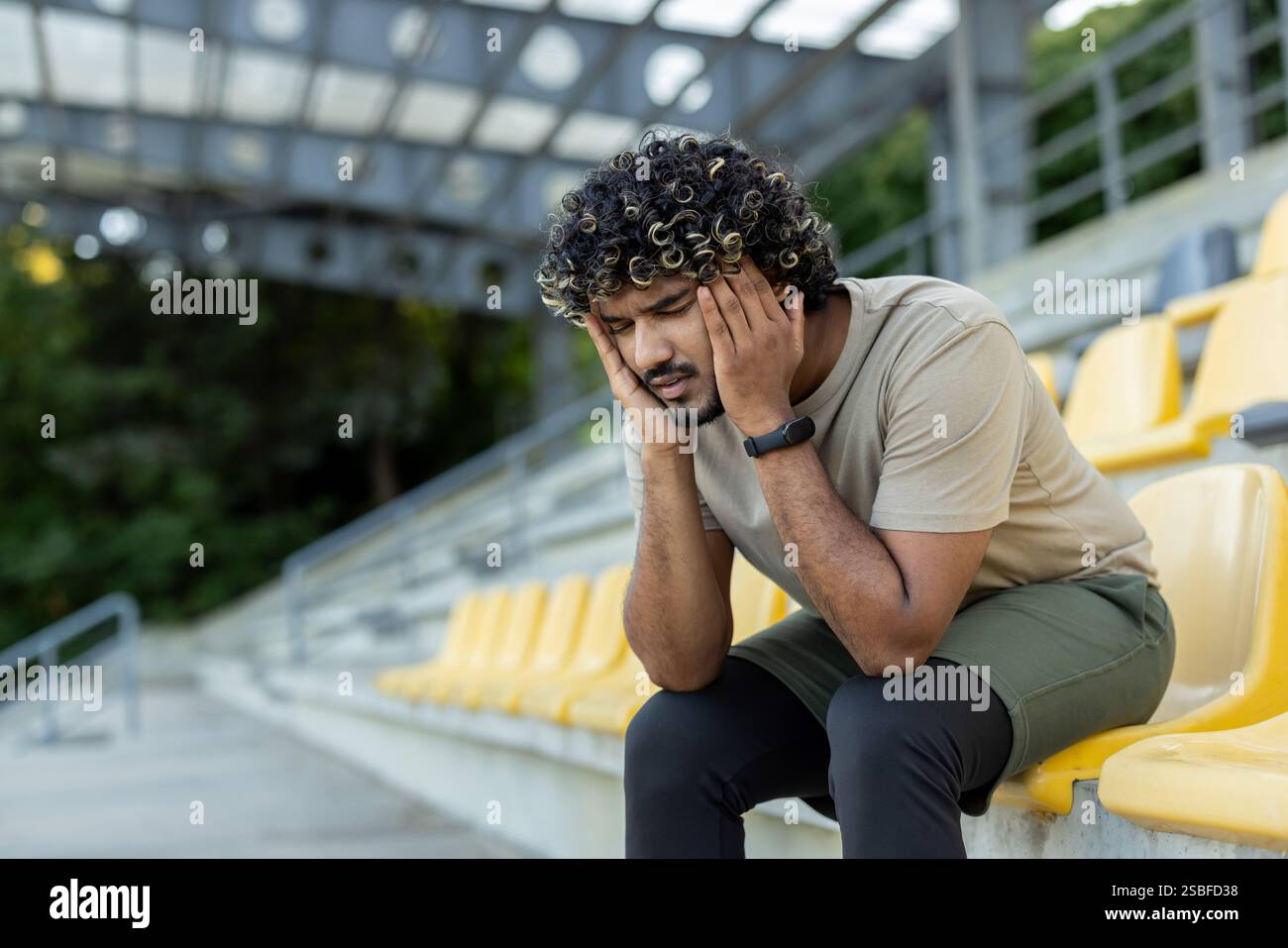 Sad man sitting and resting after active physical exercise and fitness ...