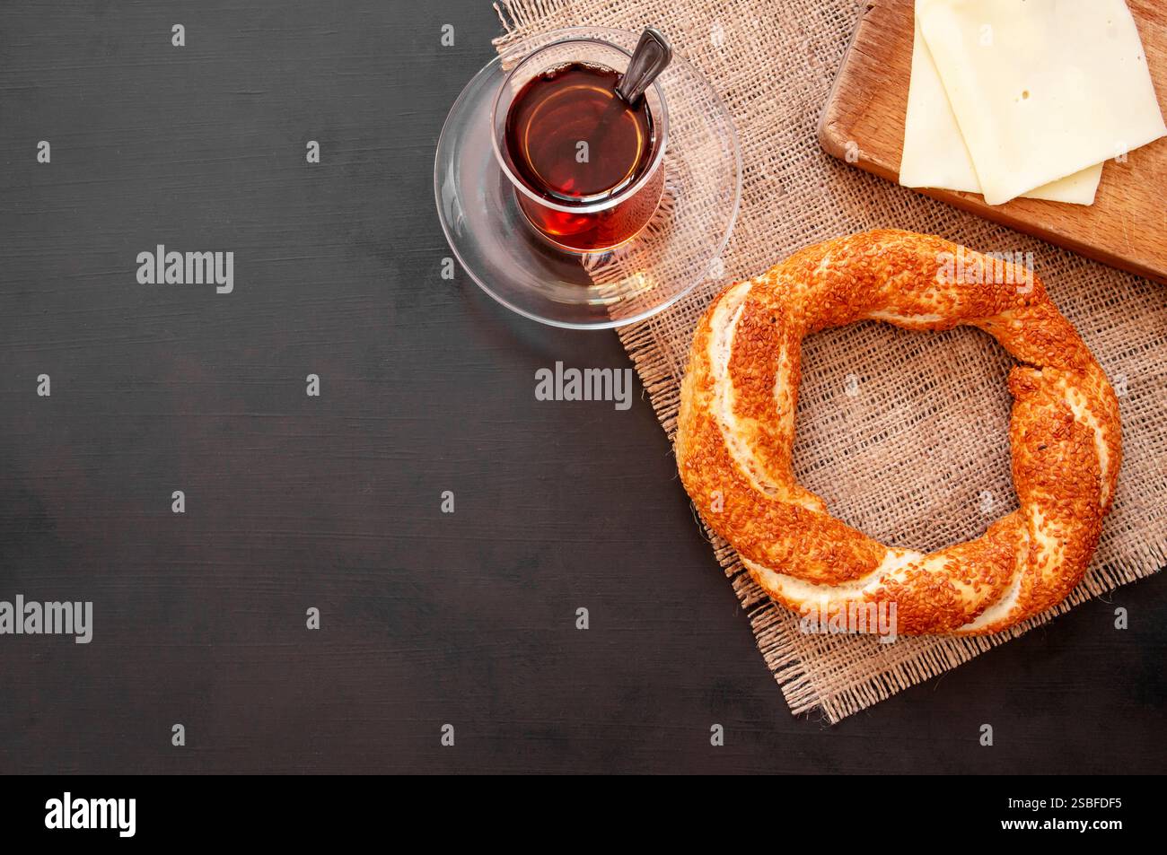 Crispy Turkish traditional bagel / simit with sesame and glass of ...