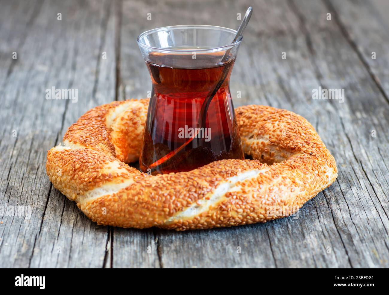 Crispy Turkish traditional bagel / simit with sesame and glass of ...
