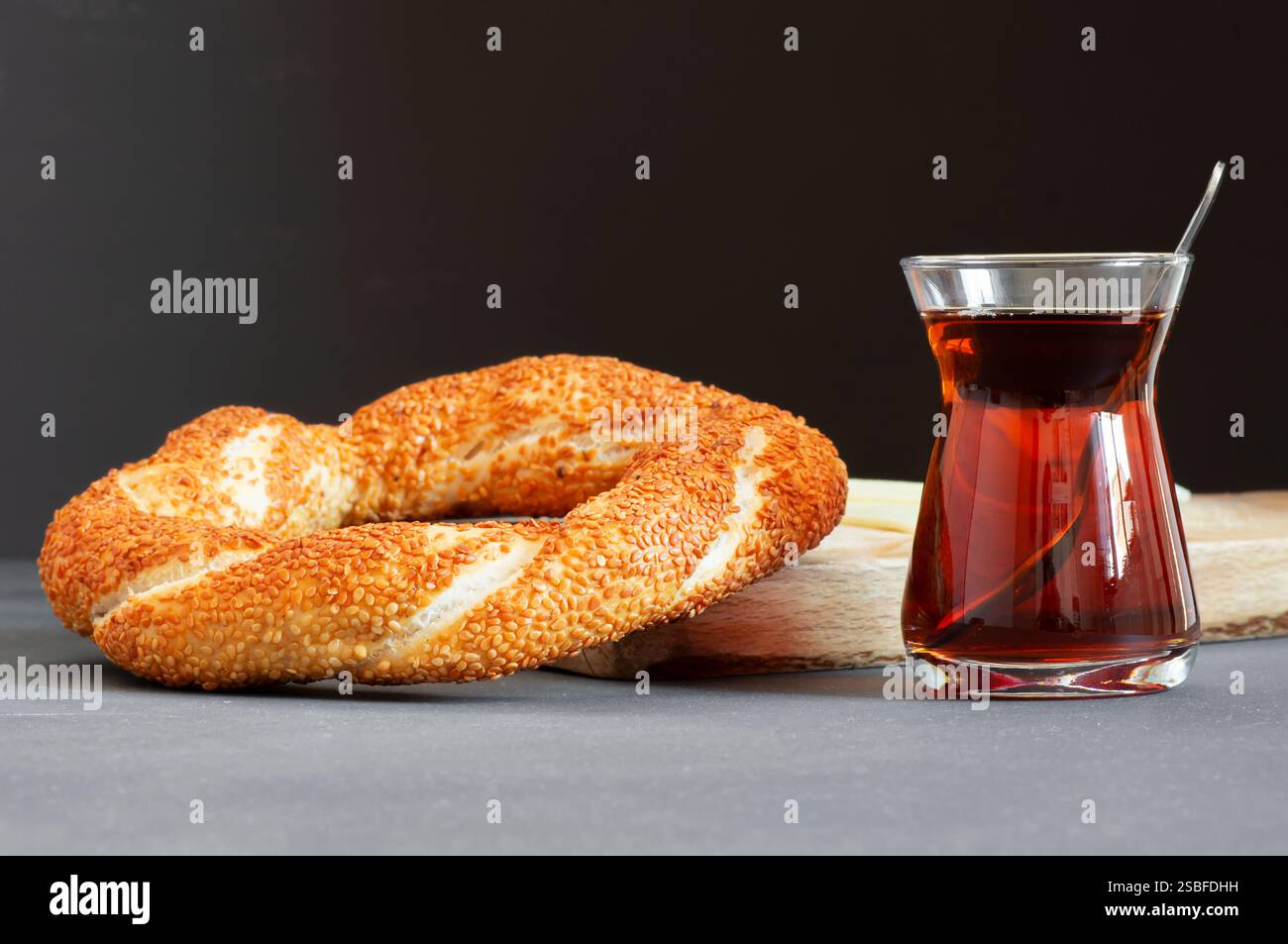 Crispy Turkish traditional bagel / simit with sesame and glass of ...