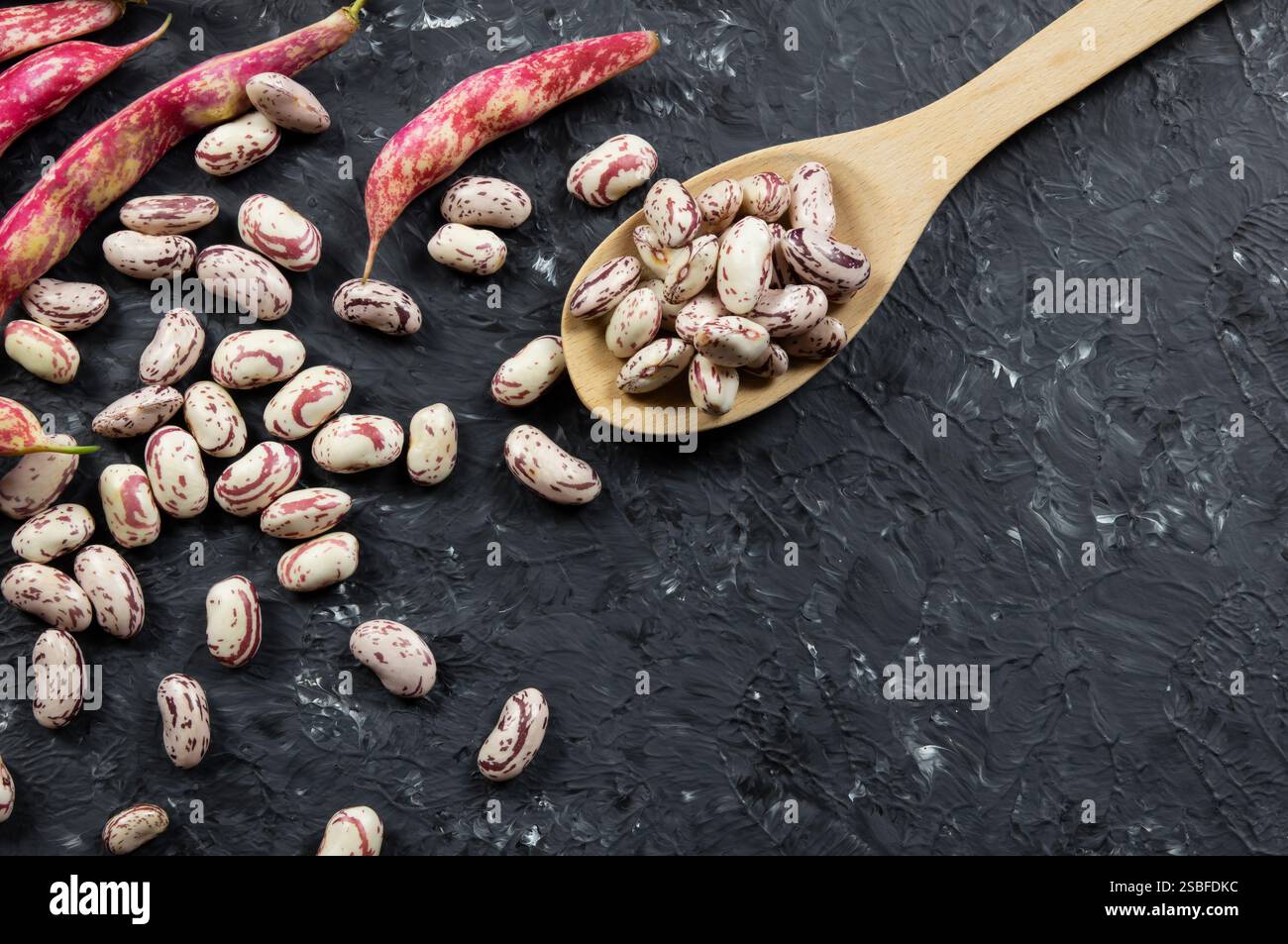 Harvested uncooked dried roman beans with raw pod plant on rustic ...