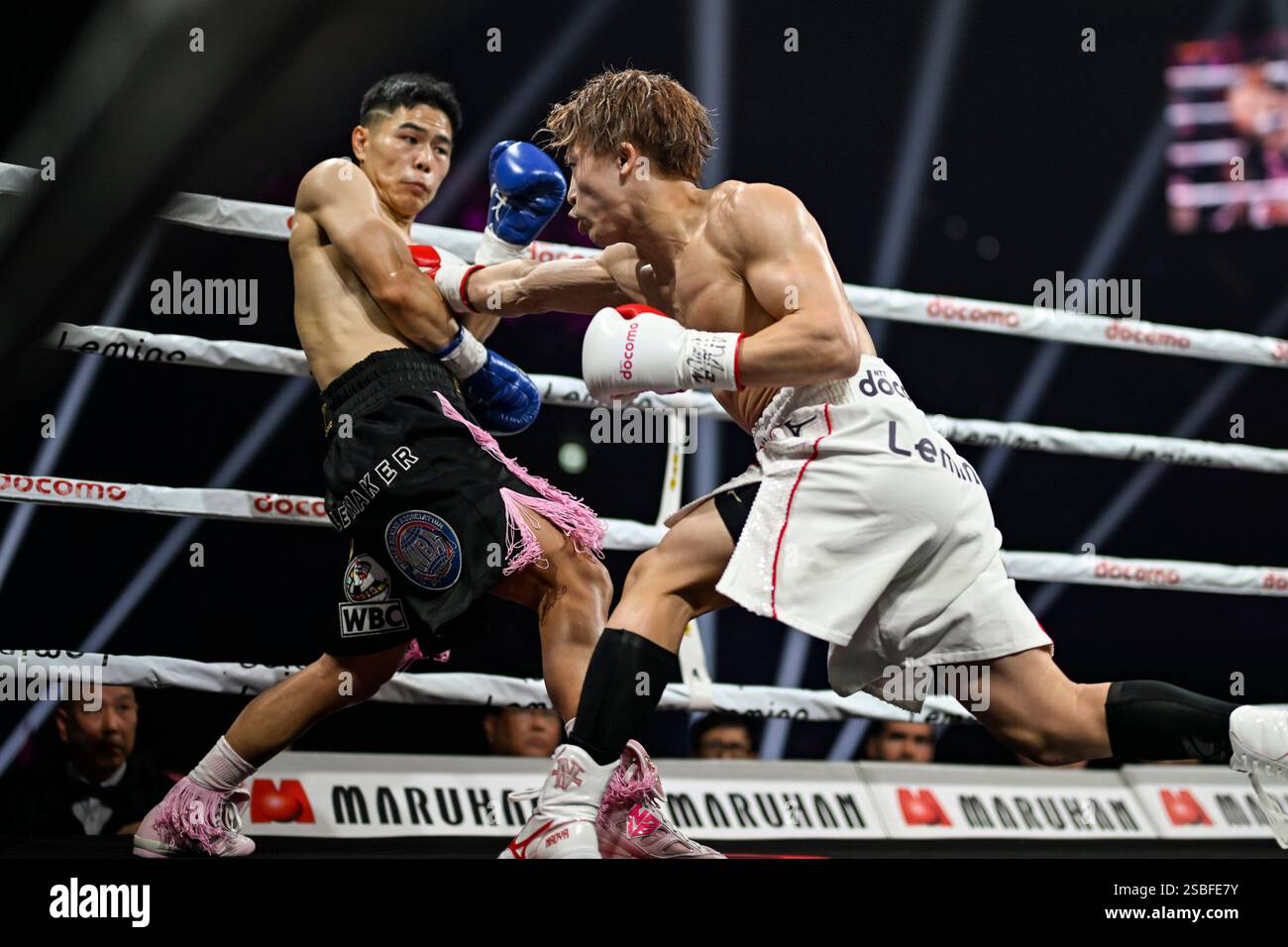Champion Naoya Inoue (white gloves) of Japan and challenger Kim Ye-joon of South Korea compete ...
