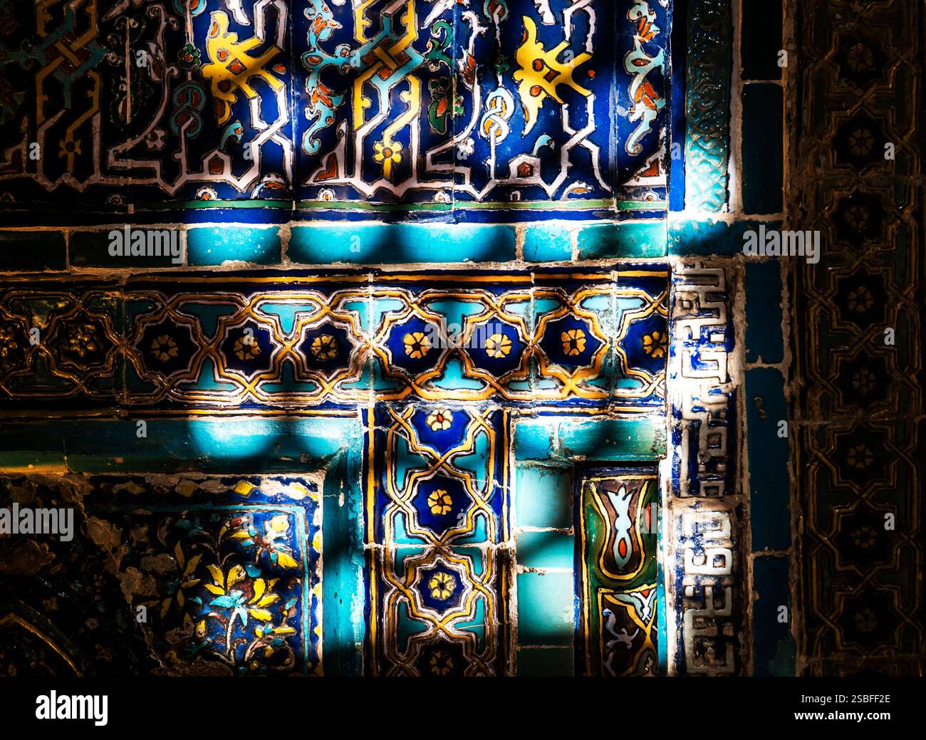 Intricate tile work featuring blue and gold patterns illuminated by ...