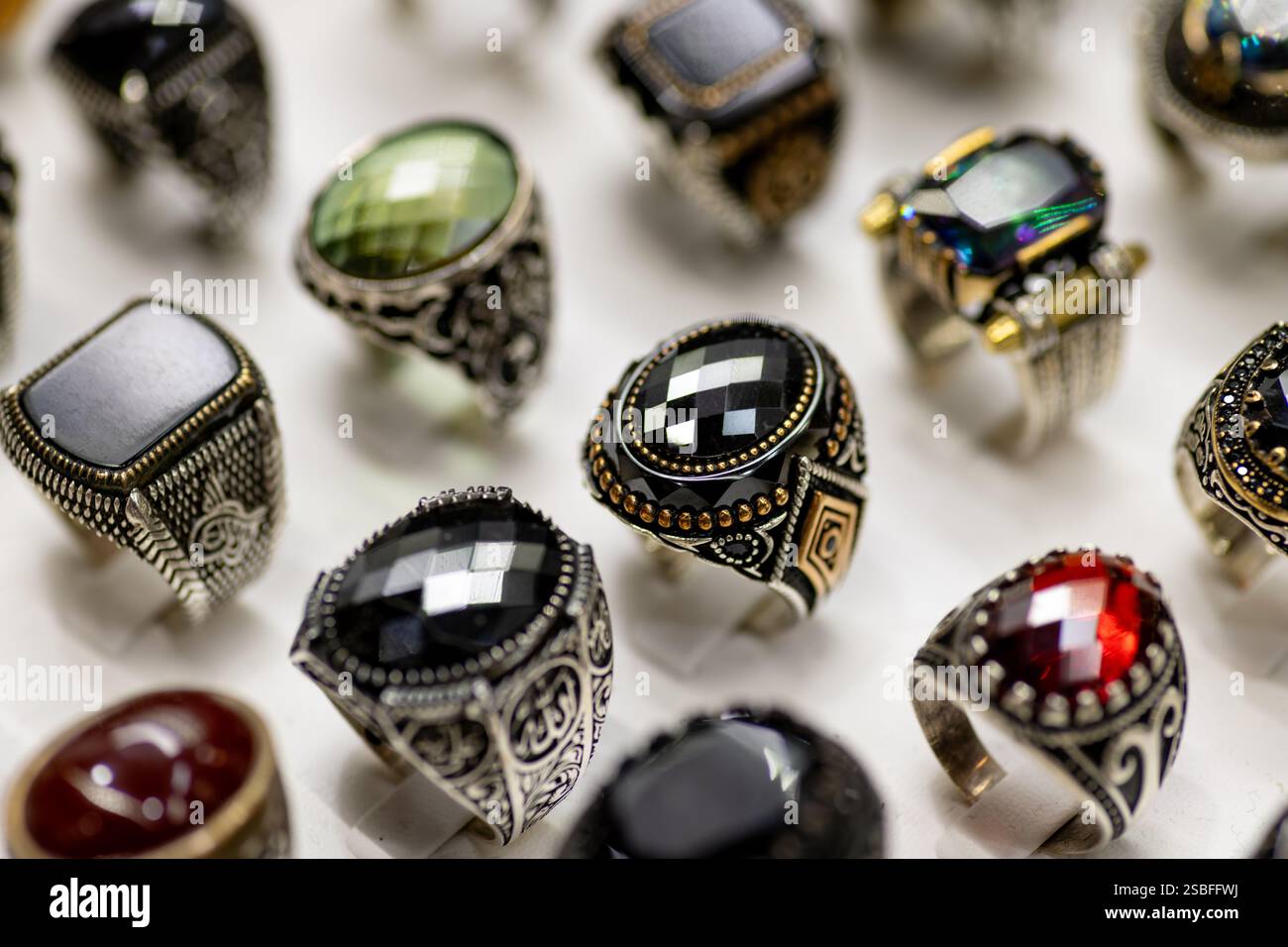 A close-up of multiple gemstone rings with unique designs, elegant ...