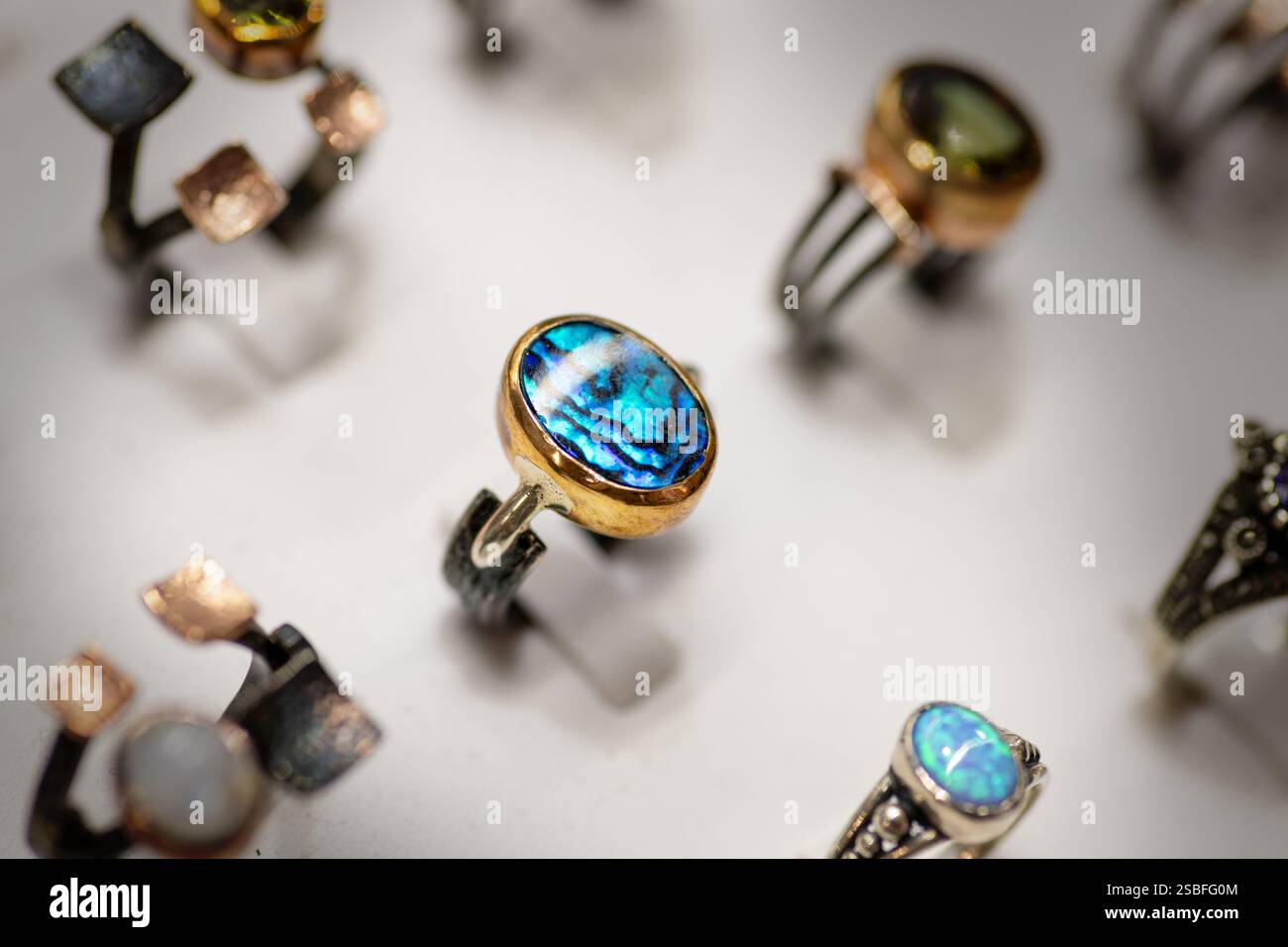 A close-up of multiple gemstone rings with unique designs, elegant ...