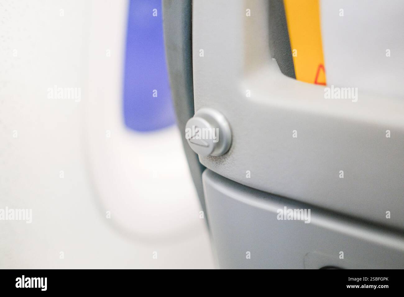 Detail of a small bag hanger at the back of the armchair of a passenger ...