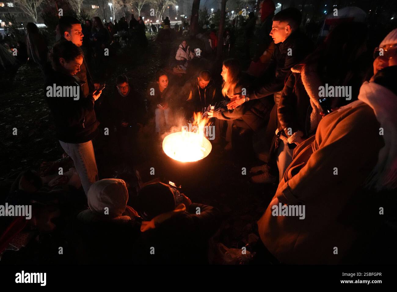 Serbia's striking students warm themselves by the fire during long ...