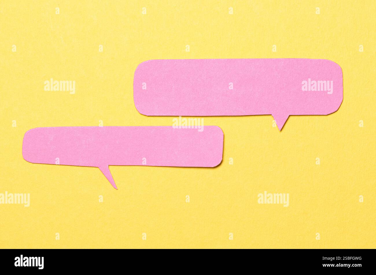 Pink blank cut out paper speech bubbles with copy space for text on ...