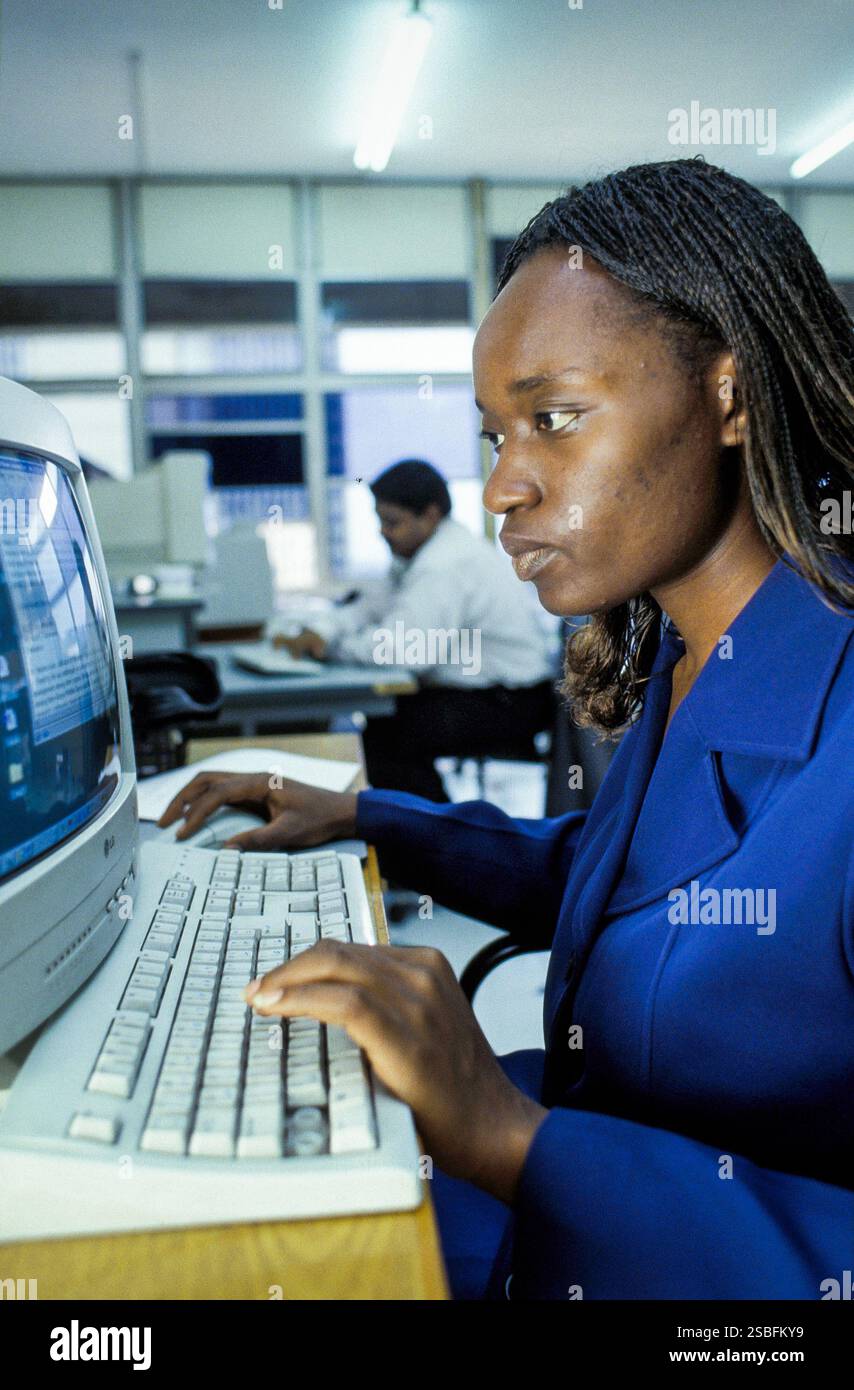 Kenia, Nairobi - Female employee of the internetcompany KeniaWeb uses a ...