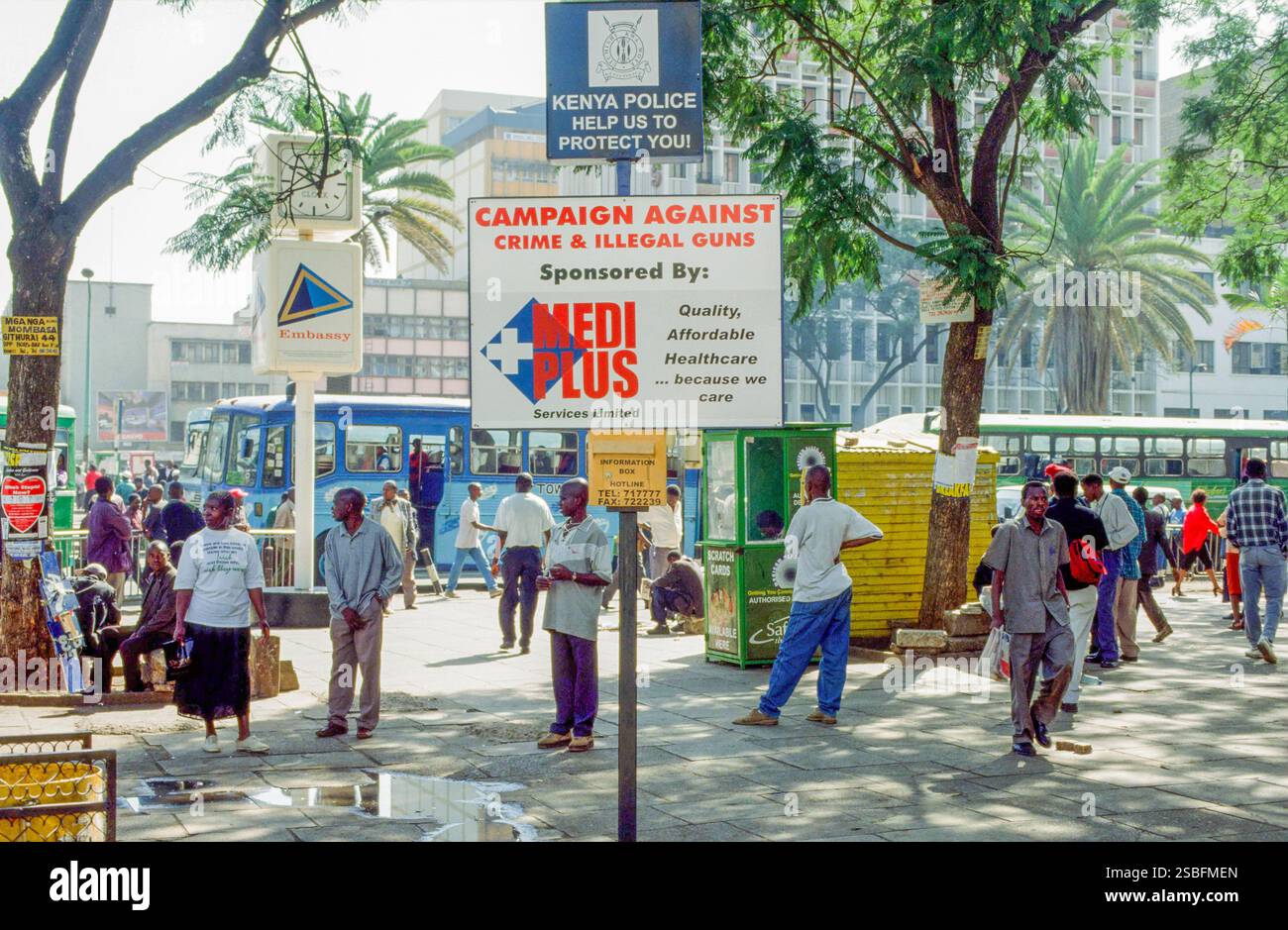 Kenya, Nairobi. Bus station with sign warning against crime and illegal ...