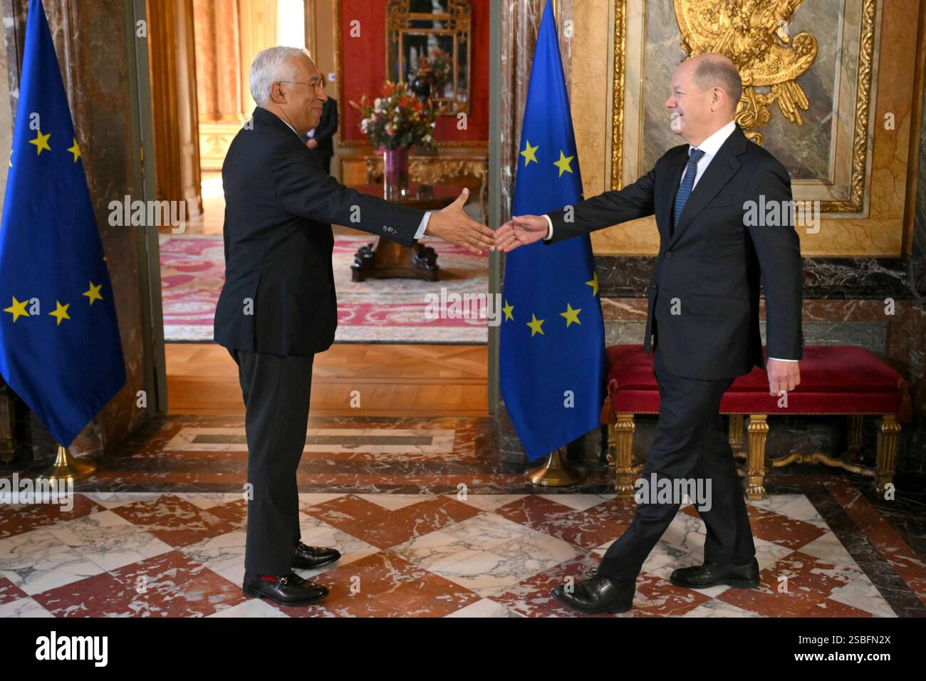 European Council President Antonio Costa, left, greets Germany's Chancellor Olaf Scholz as he ...
