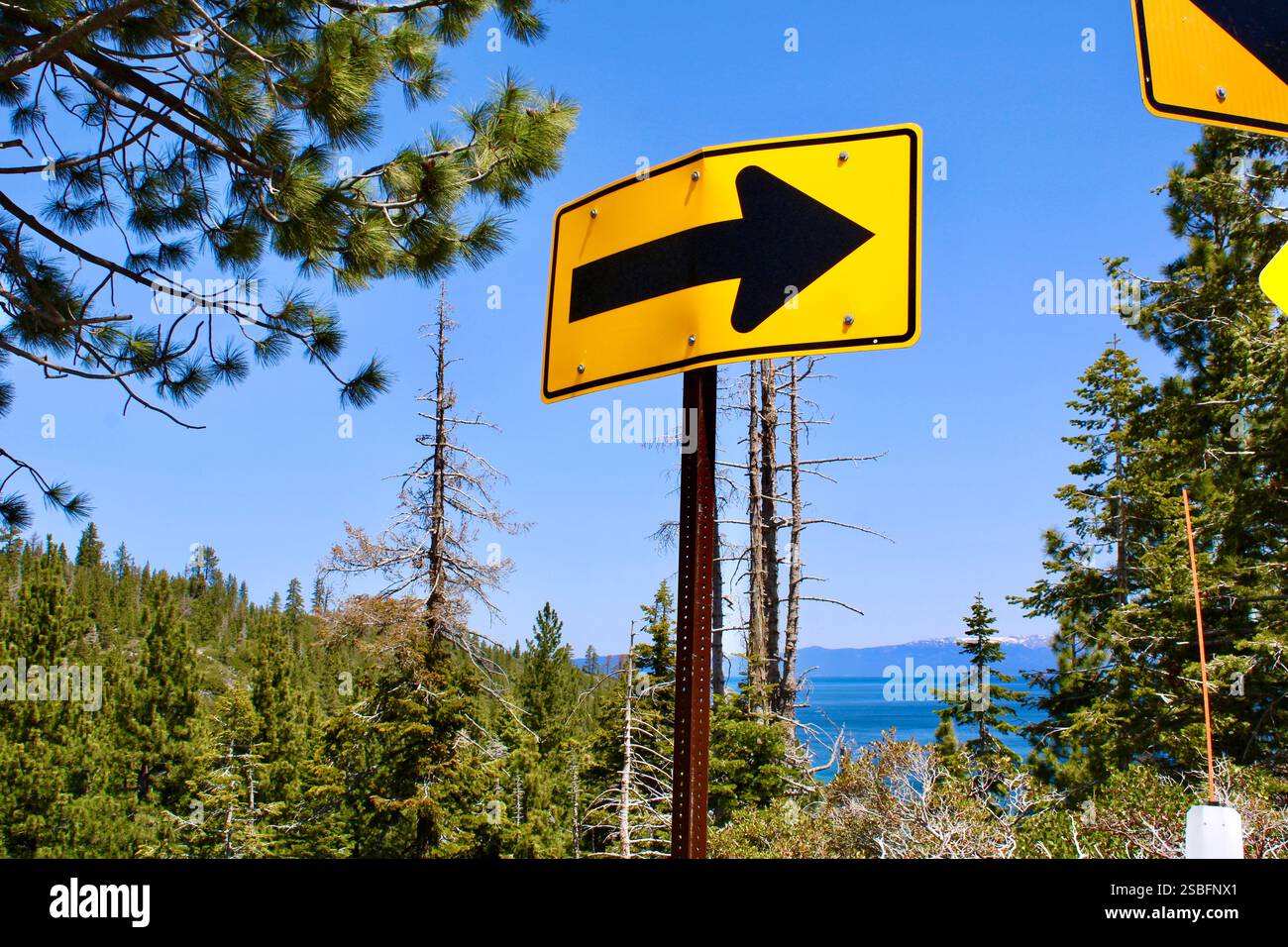 Bright yellow arrow road signs Stock Photo - Alamy