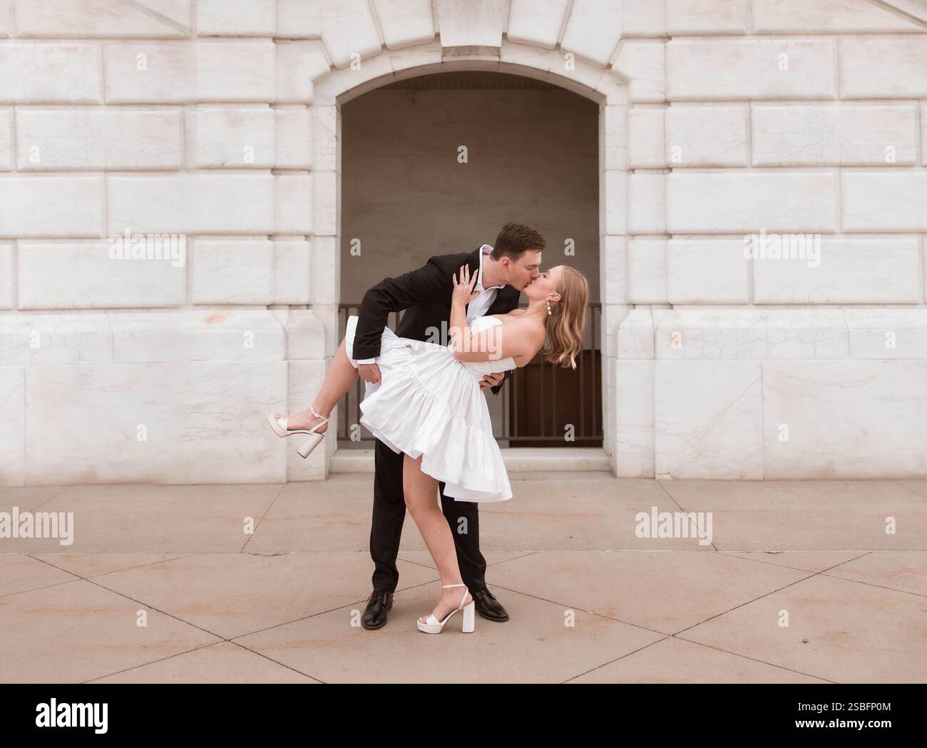 Couple shares a romantic dip kiss in front of the DIA Stock Photo - Alamy